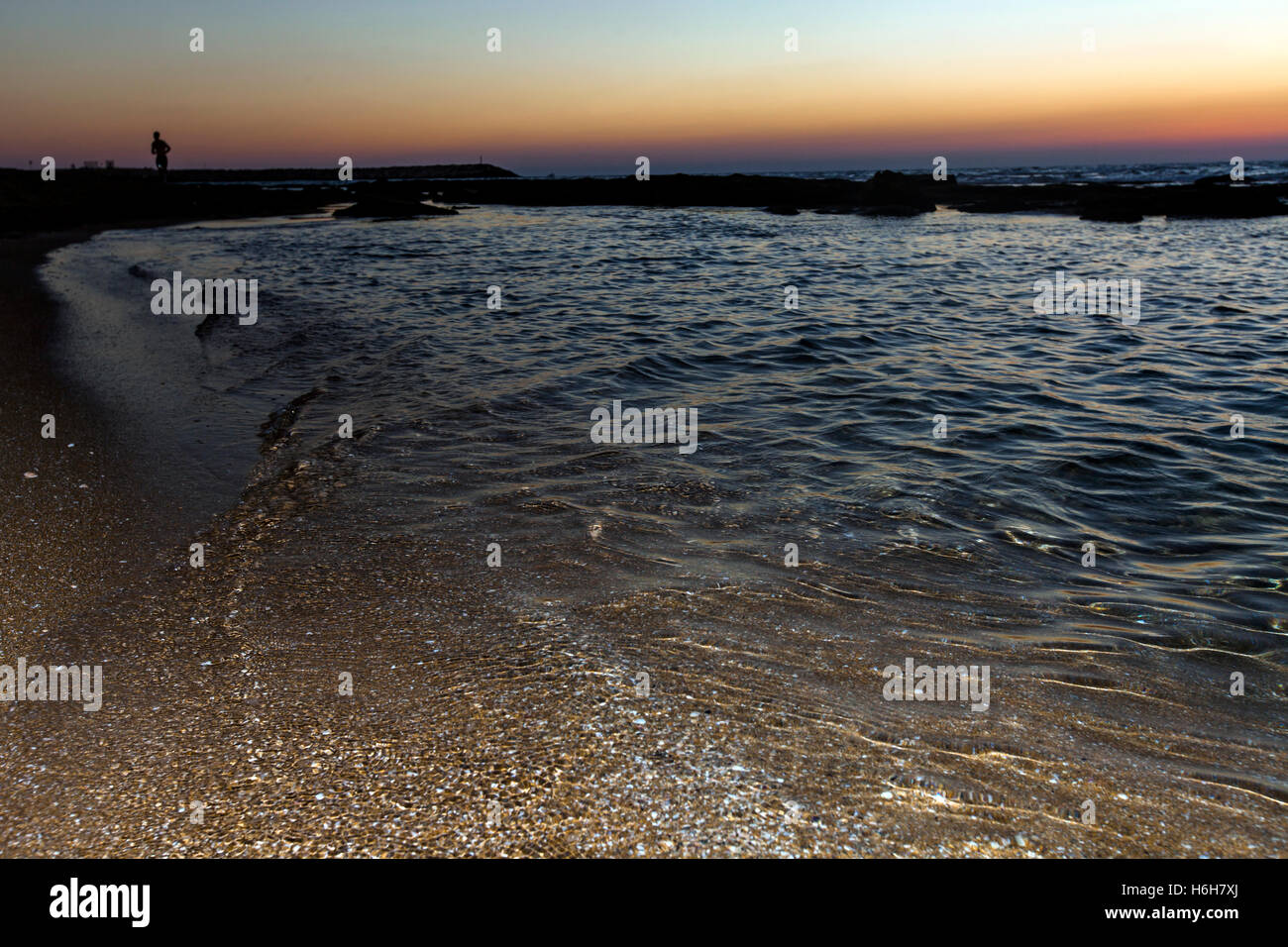 Shallow sea water illuminated in conjunction by flash and by last of ...