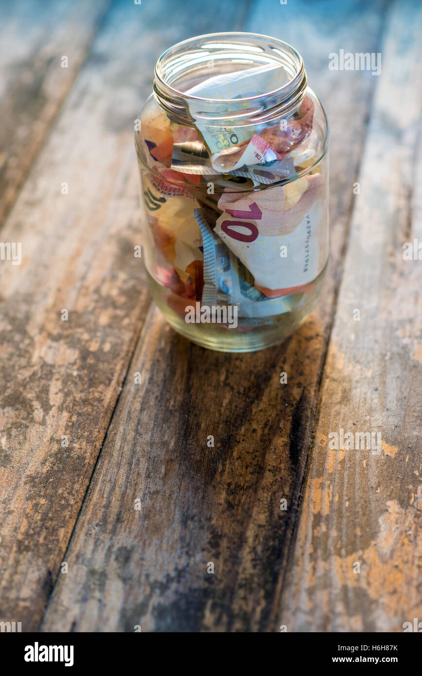 Cash in money jar hi-res stock photography and images - Alamy