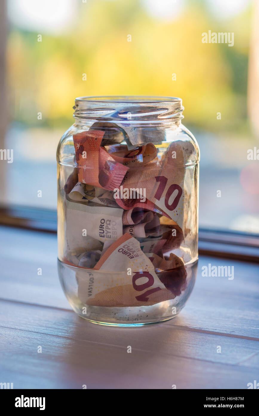 Cash in money jar hi-res stock photography and images - Alamy