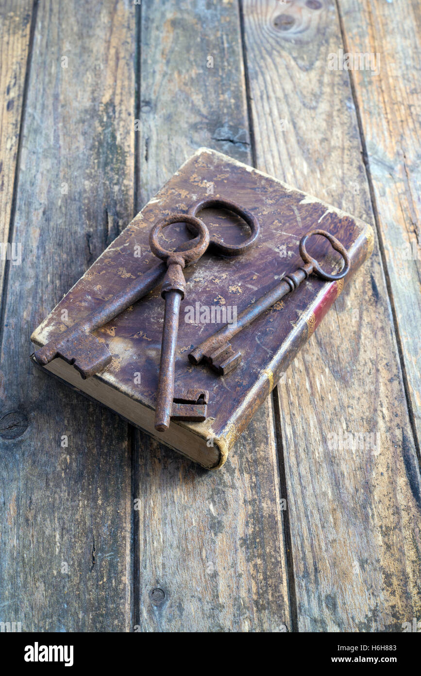 old keys on a old book, antique wood background Stock Photo - Alamy