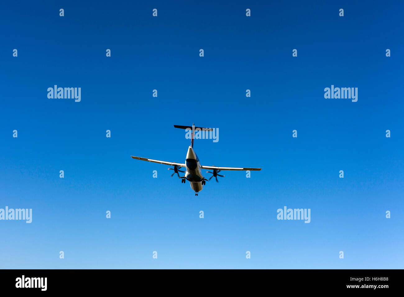 A small propeller airplane flying on a clear day Stock Photo - Alamy