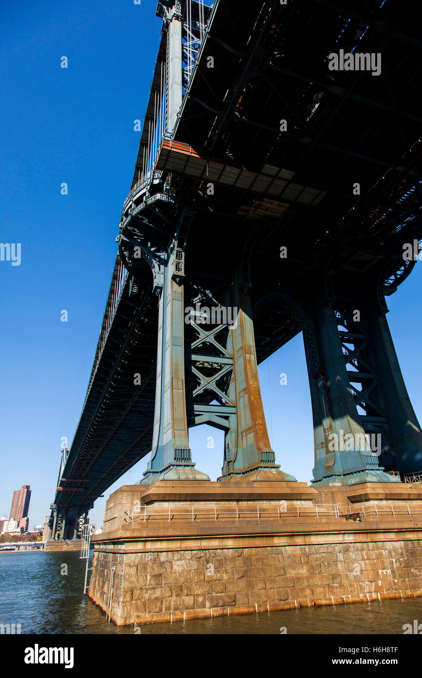The Brooklyn Bridge stretching above the east river, with the Lower ...