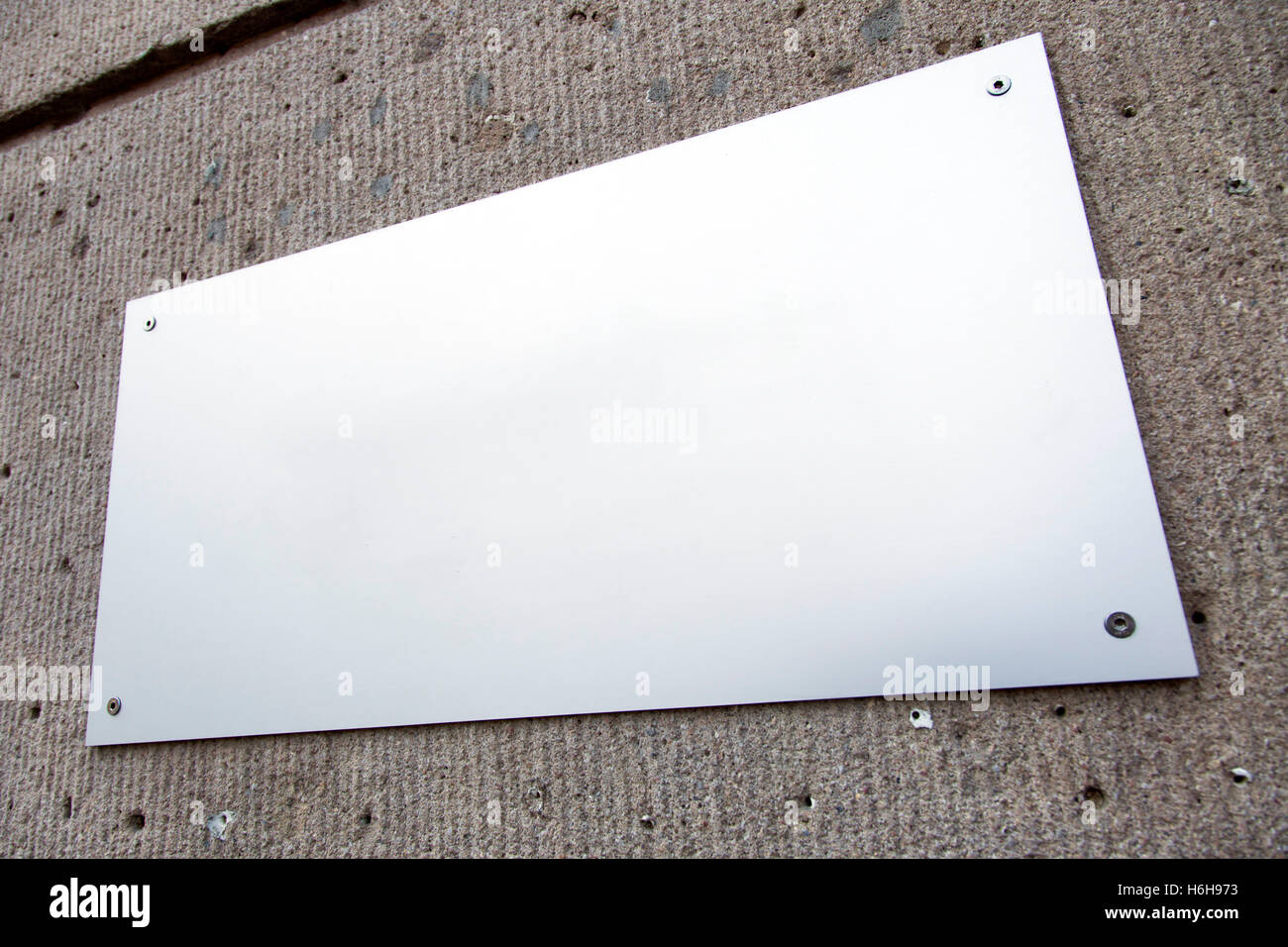 Silver metal sign ready for copy, on concrete wall Stock Photo - Alamy