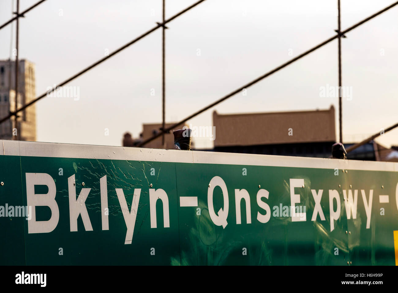 Sign above a highway depicting the way to the Brooklyn-Queens ...