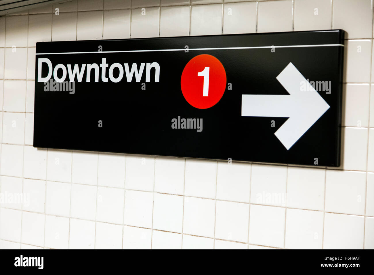 Sign depicting pointing the direction to the number 1 downtown bound ...
