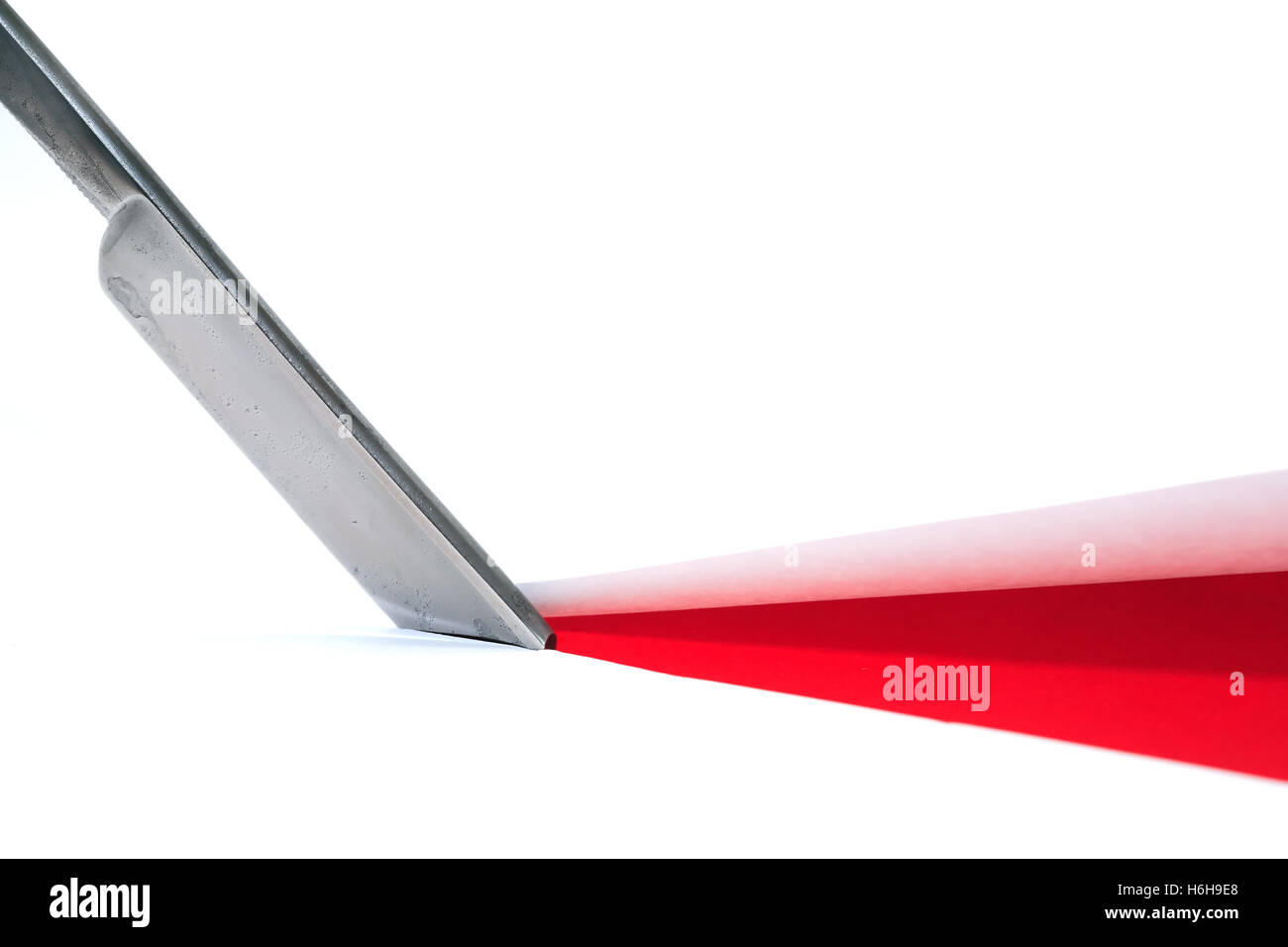 Old straight razor cutting white paper with red color inside Stock ...