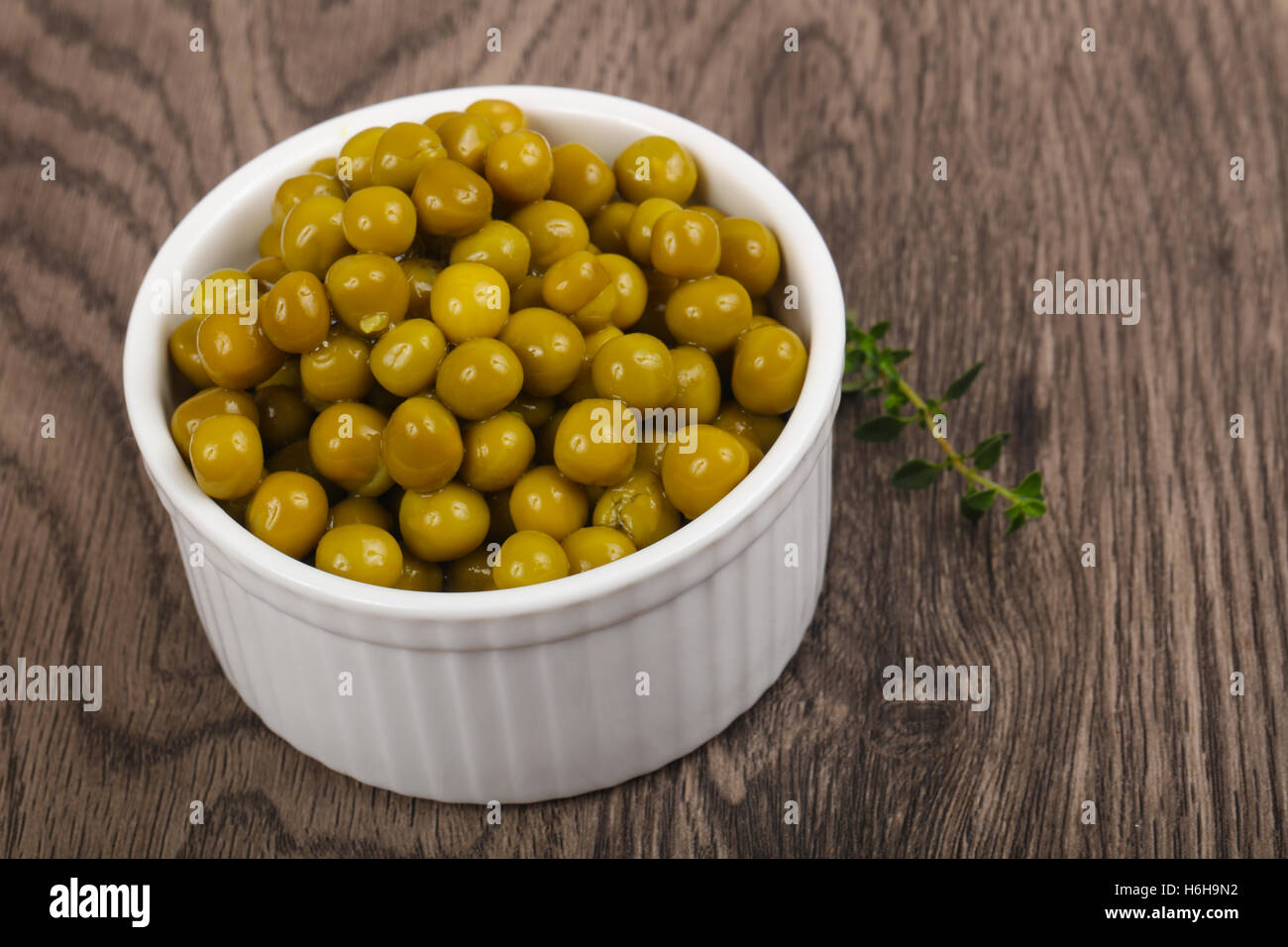 Pickled pea in the plate over wooden background Stock Photo - Alamy