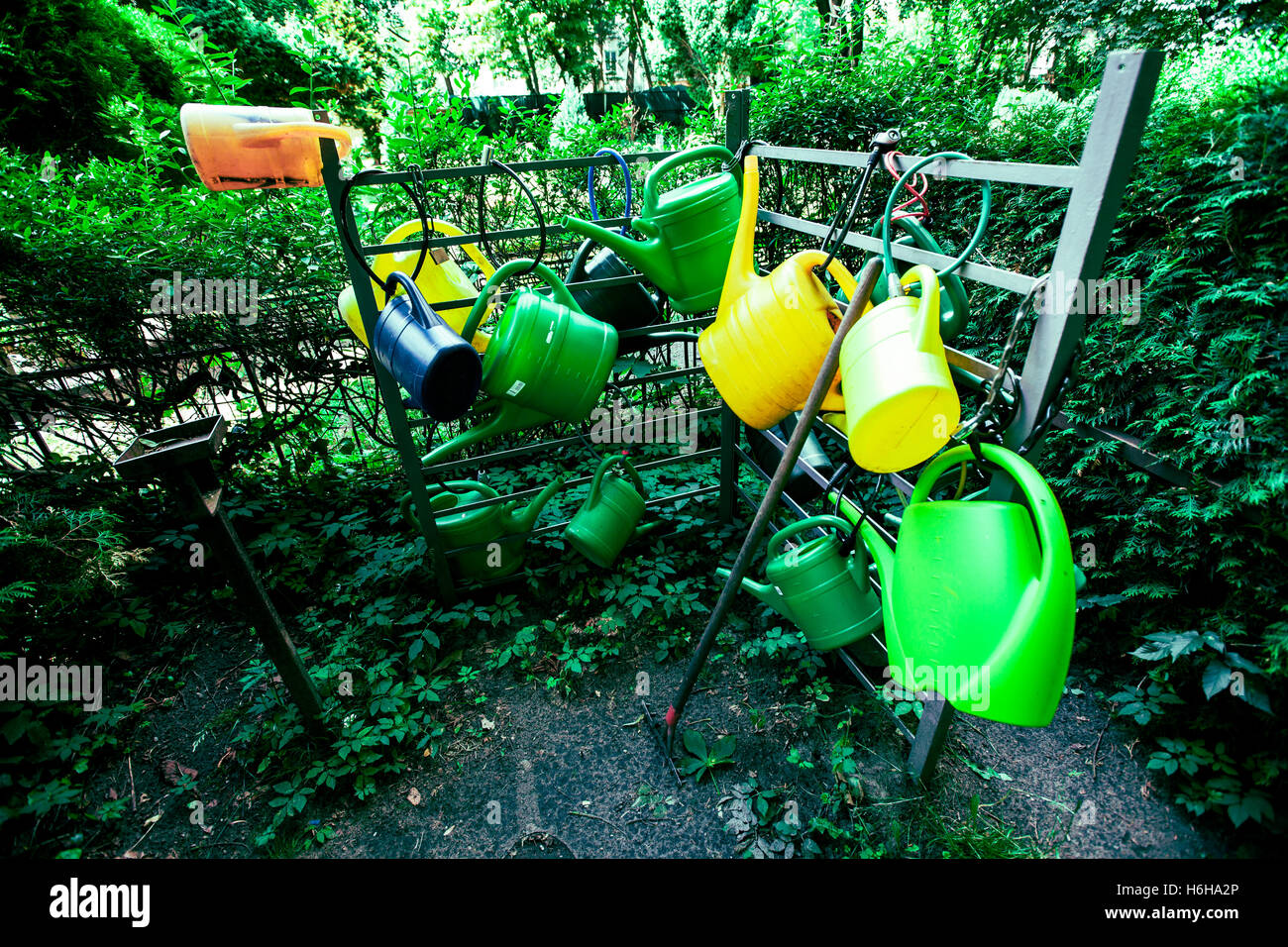 Numerous garden funnels locked onto a metal stand in a public garden ...