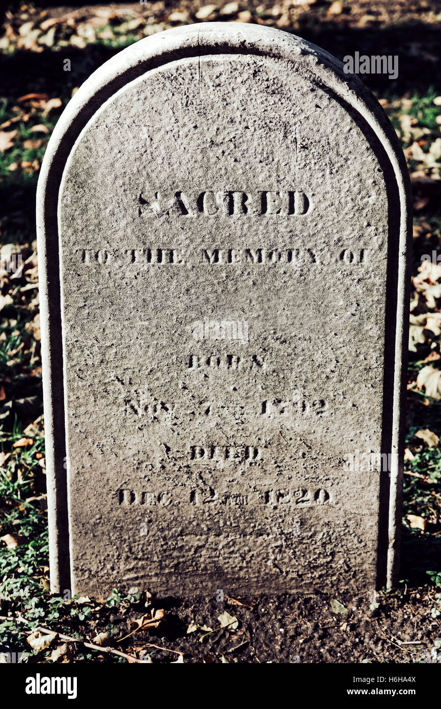 An old tombstone marks a grave in a graveyard Stock Photo - Alamy