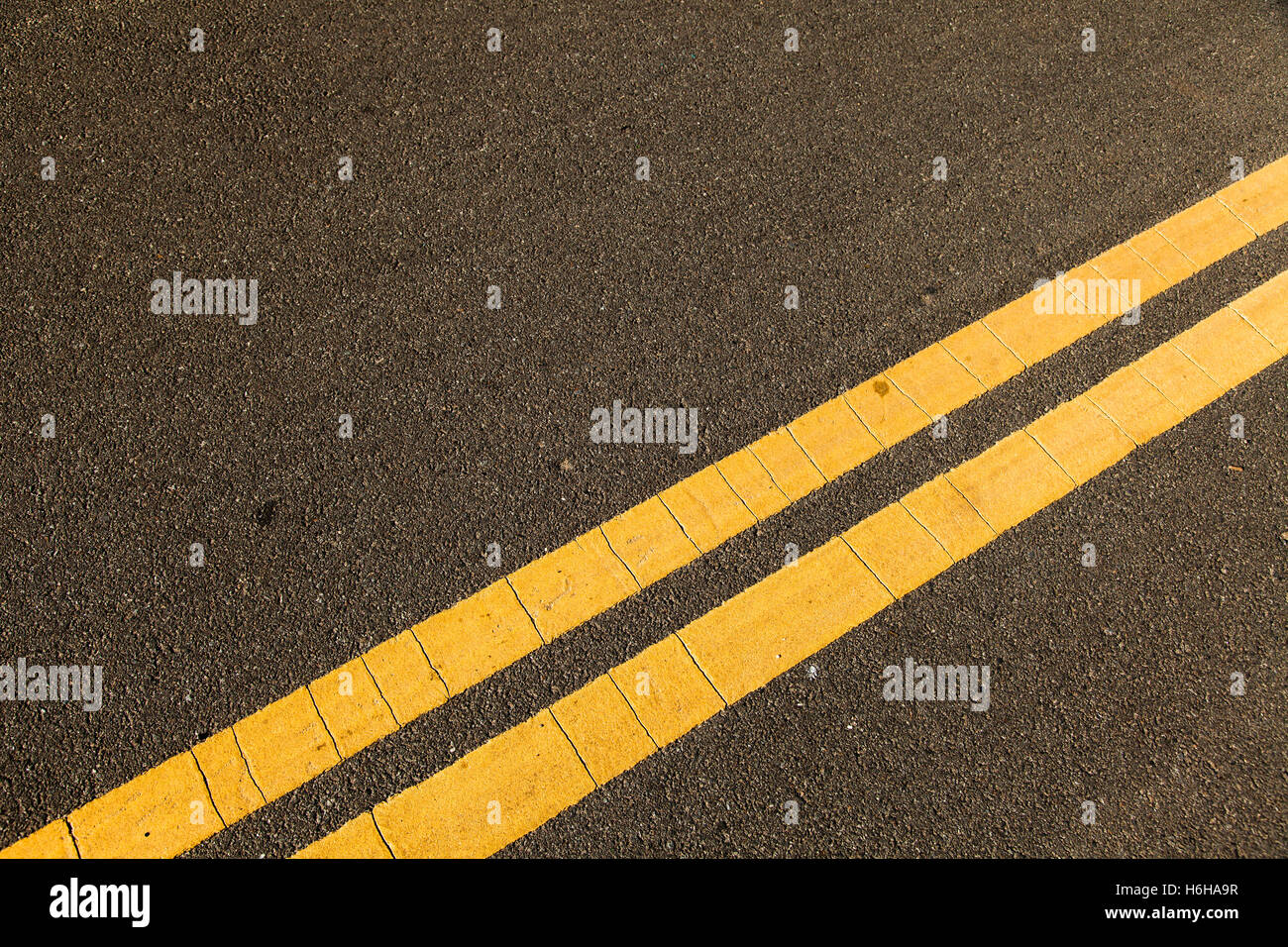 Detail view of asphalt road with white line markings on it Stock Photo ...
