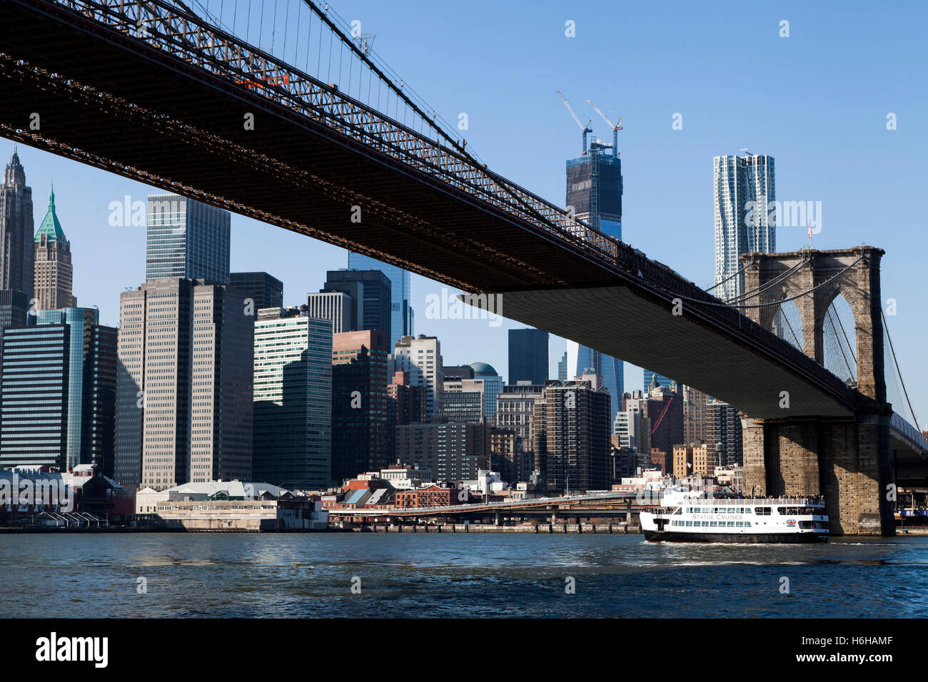 NEW-YORK - NOV 17: Ferry on the East River below the Brooklyn Bridge ...