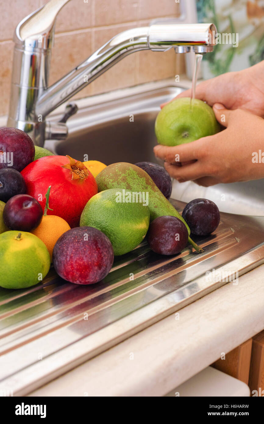 Person washing fruits in the sink Stock Photo - Alamy