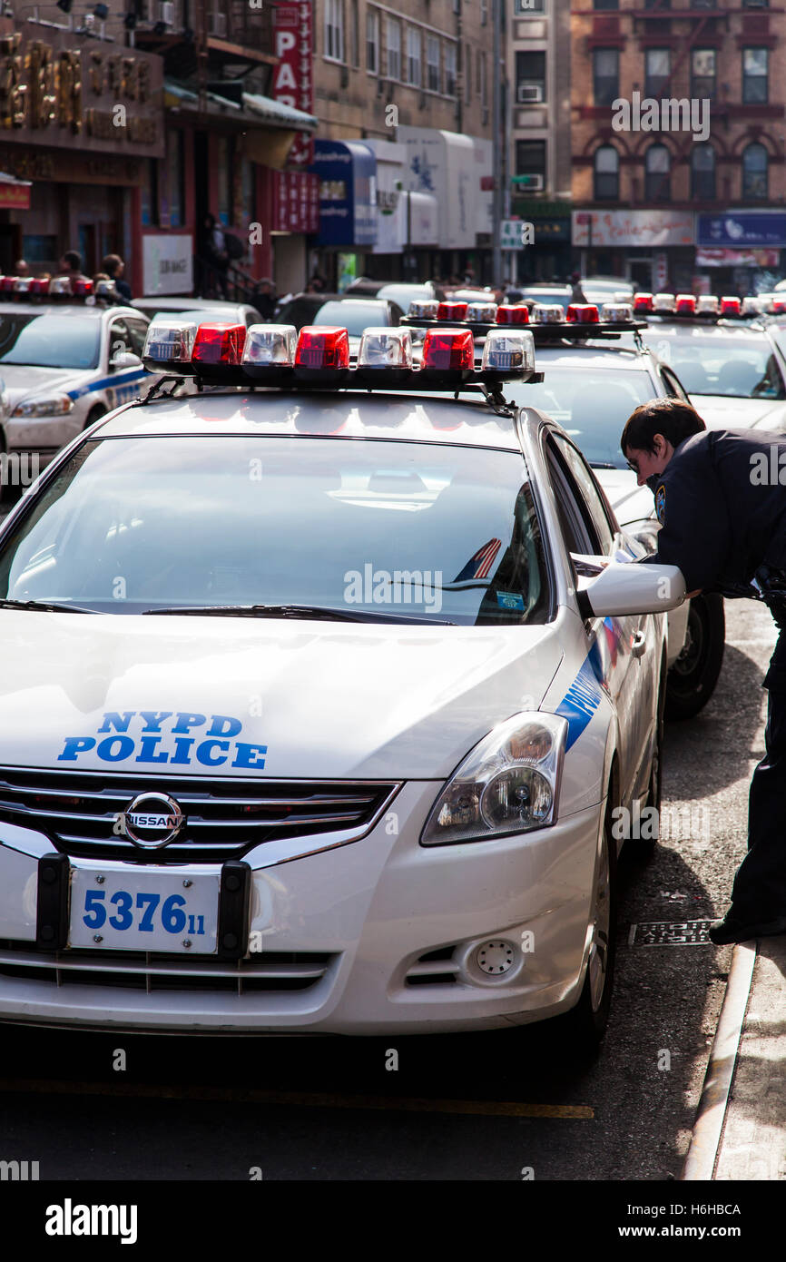 New-York, USA - NOV 18: Police officer leaning on a police car in a ...