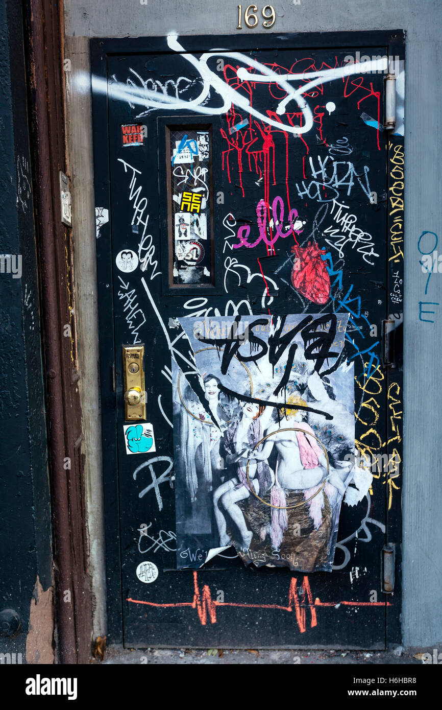 NEW-YORK - NOV 14: Building entrance door covered with street tags in ...