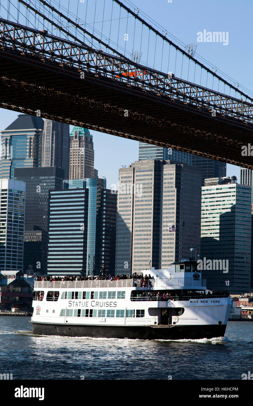 NEW-YORK - NOV 17: Ferry on the East River below the Brooklyn Bridge ...
