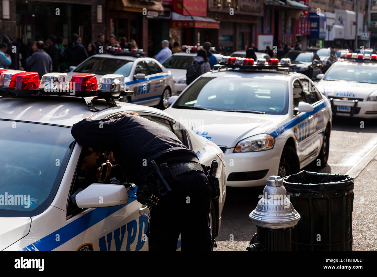 New-York, USA - NOV 18: Police officer leaning on a police car in a ...