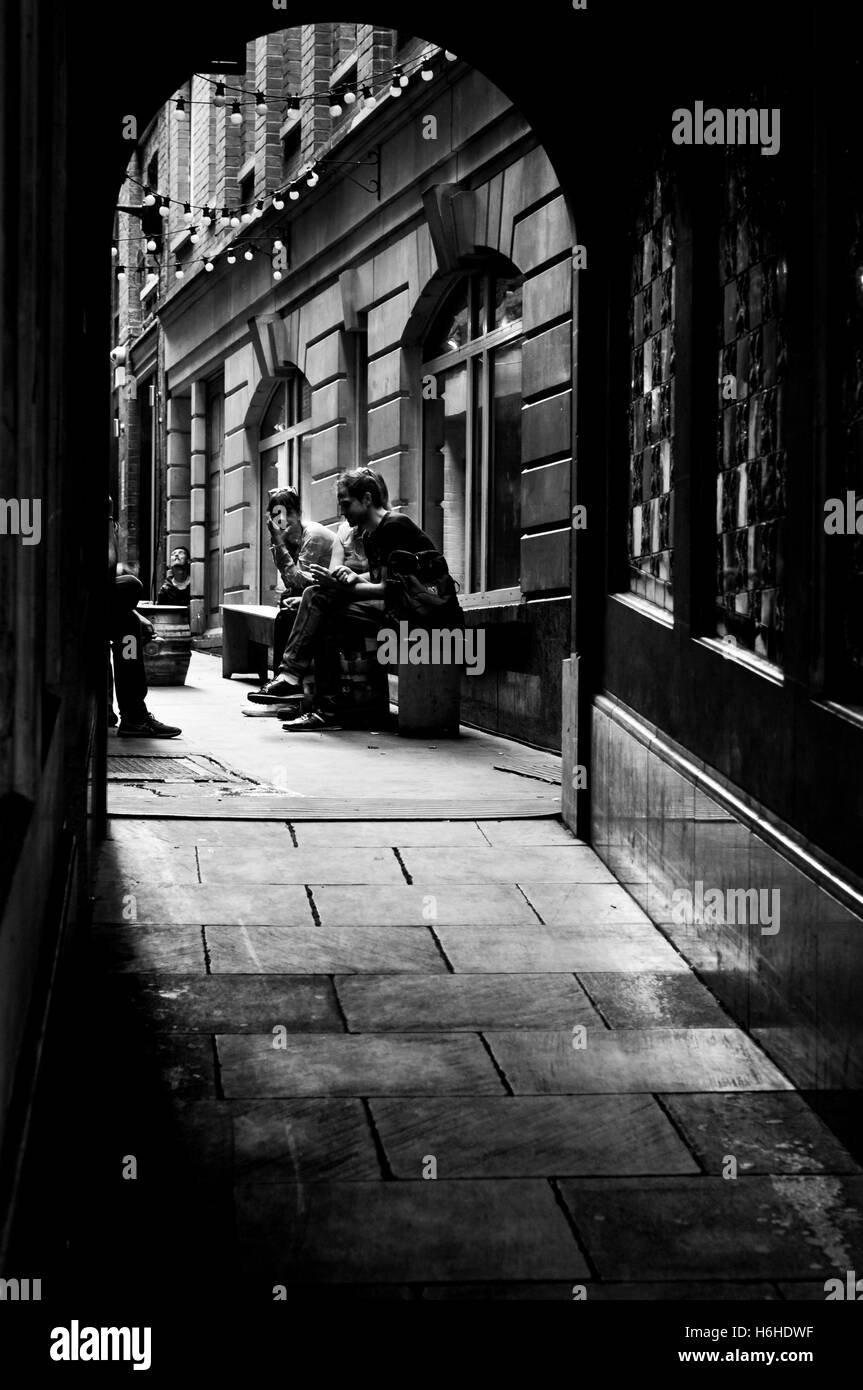 Moody, black and white image of a dark, backstreet, alley in London ...