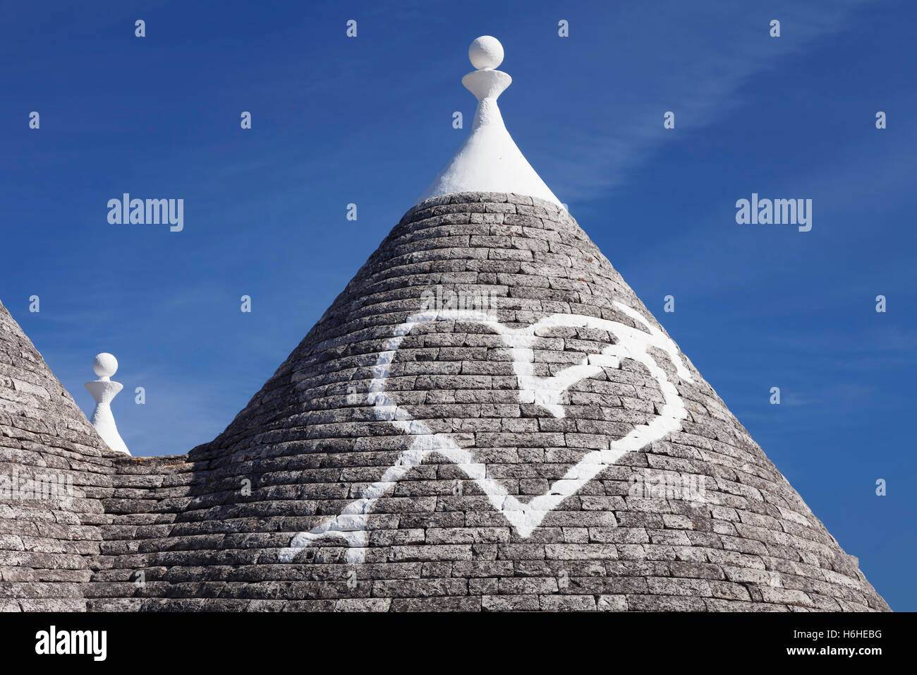 Round slate roof with heart, Trulli House, District Monti, Alberobello ...