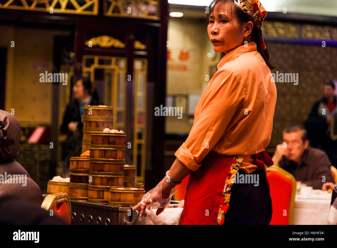 New-York, USA - NOV 18: Waitress in a busy large Chinese restaurant ...