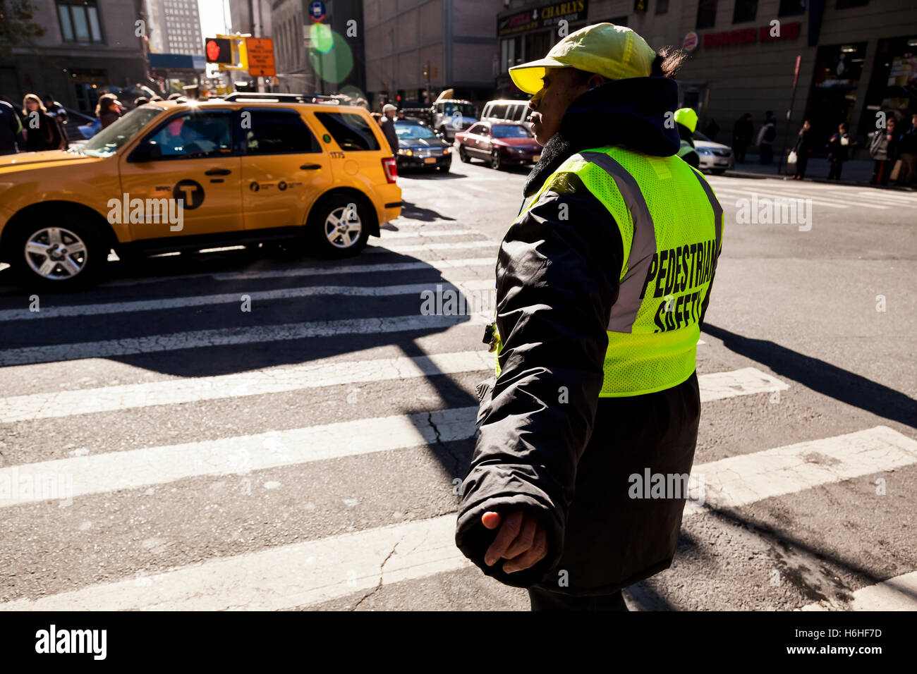 NEW-YORK - NOV 9: A pedestrian safety worker managing the traffic of ...