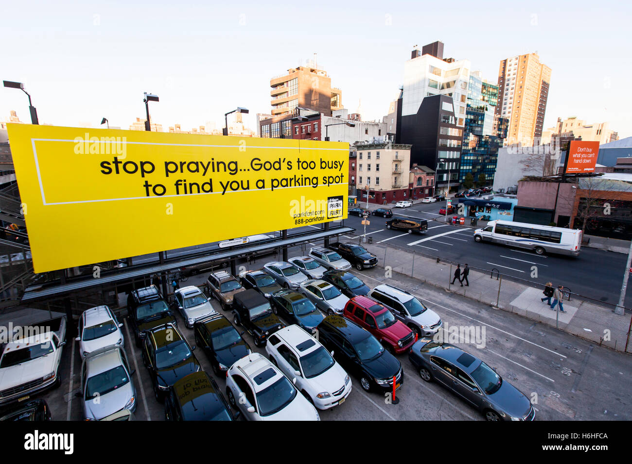 NEW-YORK - NOV 17: Giant yellow billboard rising above the parking lot ...