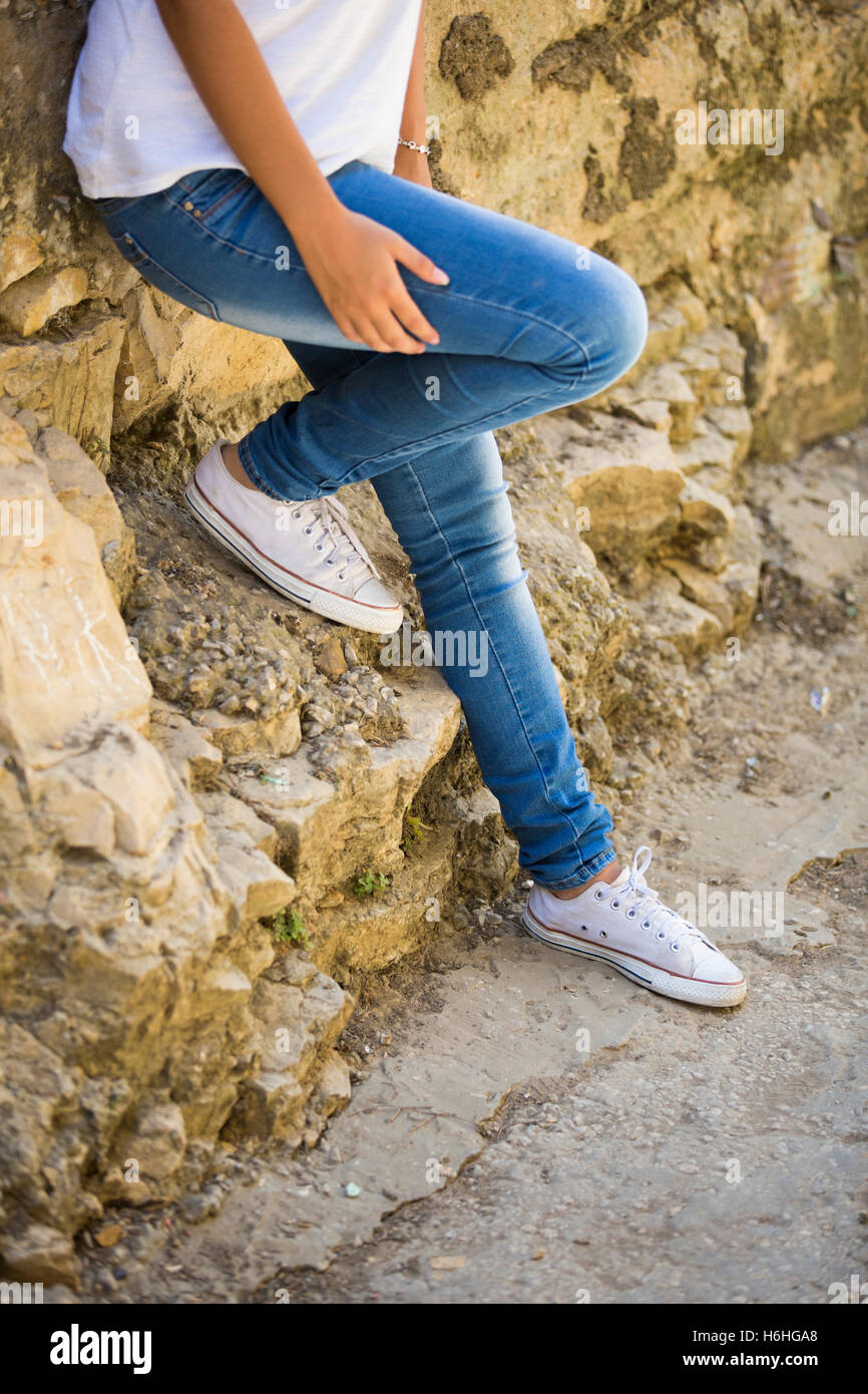 Young woman leaning against the wall Stock Photo - Alamy