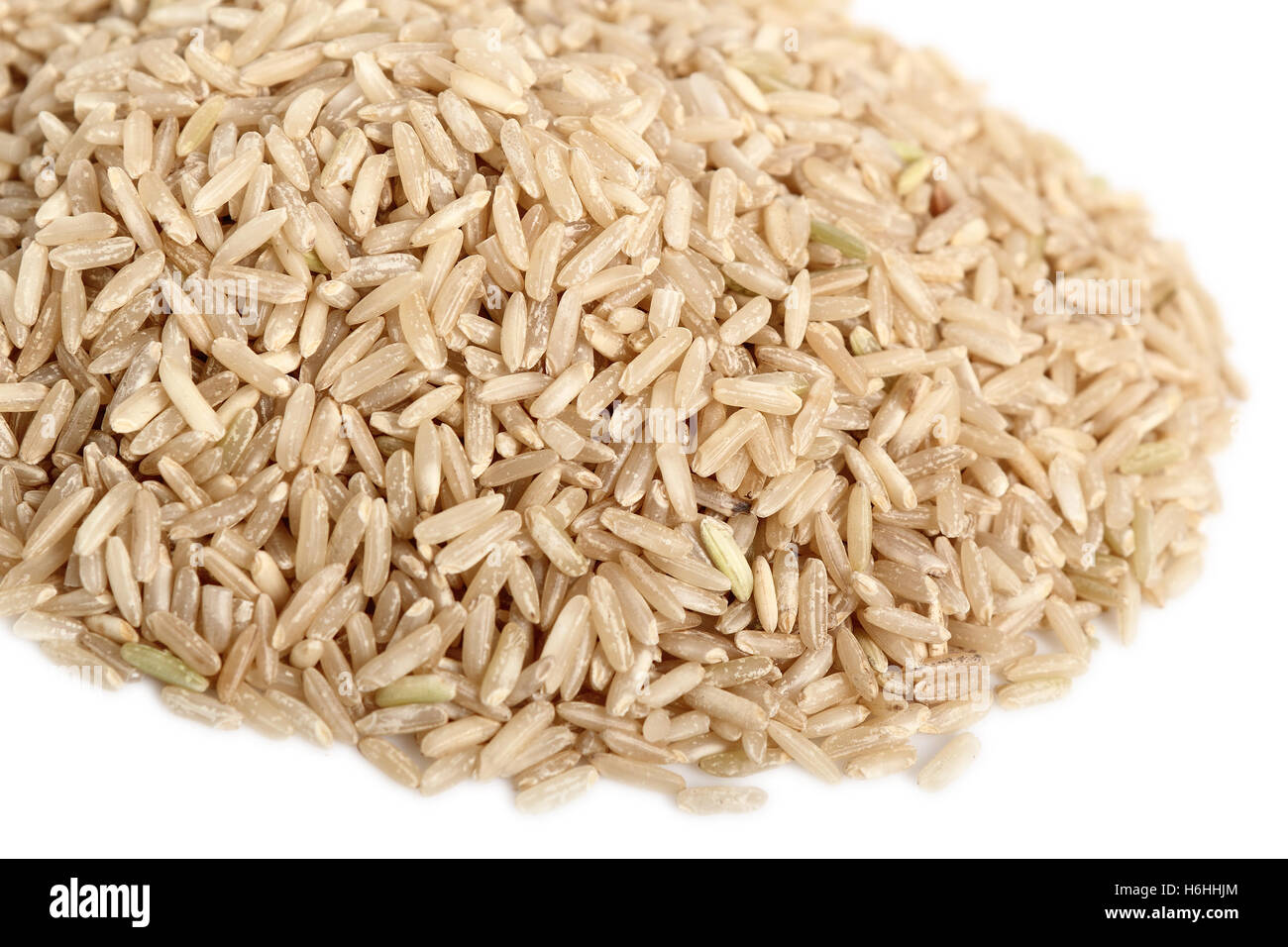 Pile of long grain brown rice. Isolated on white background. Macro ...