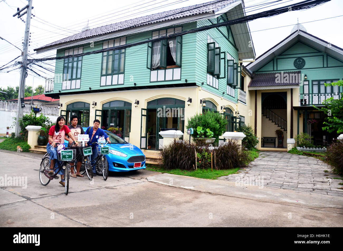 Traveller thai people posing with bicycles stop at classic house lanna style at Nan city on July ...