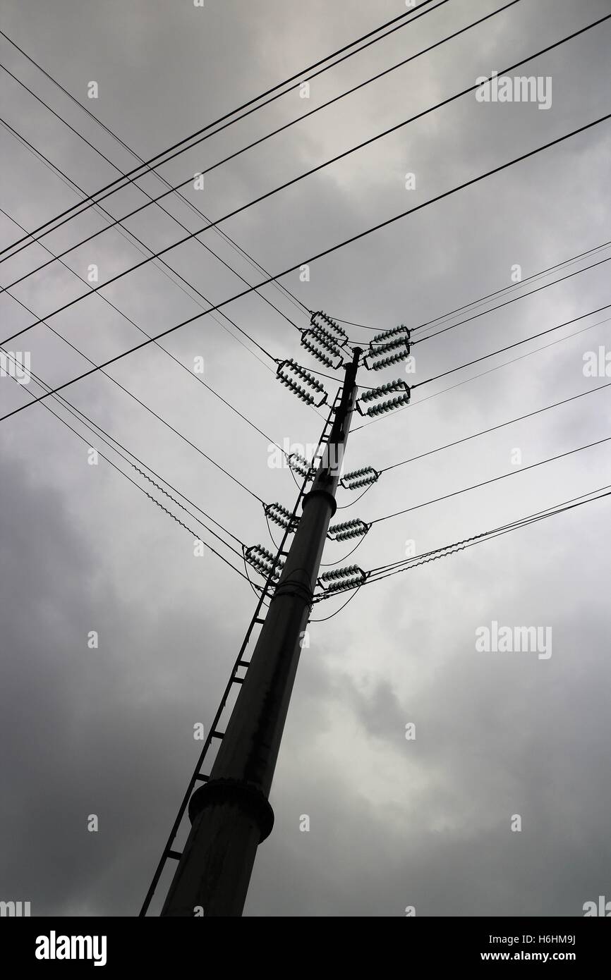 Telegraph pole and lines on overcast, moody sky Stock Photo - Alamy