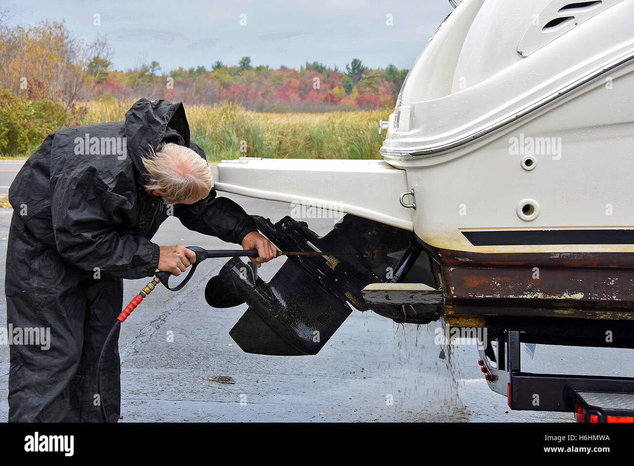 man cleaning boat prop with power washer Stock Photo - Alamy
