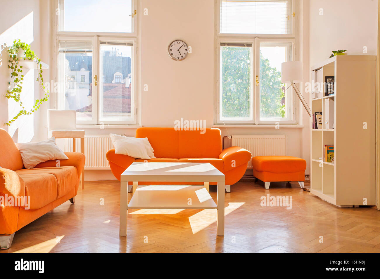 Modern,minimalist living room with resting space, racks and desk corner ...