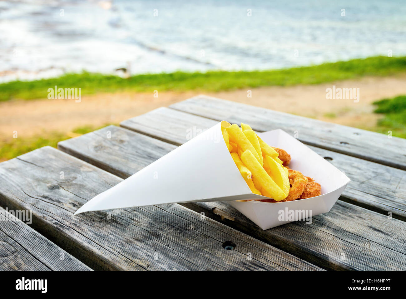 Traditional australian calamari rings with chips take away on the table ...