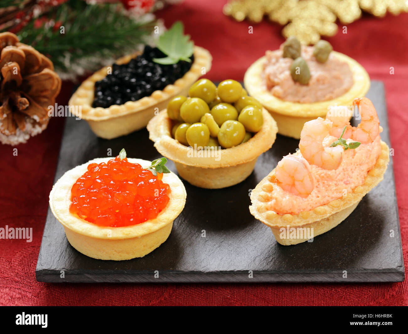 Christmas appetizers. Small tartlets with caviar and pate. Buffet and ...