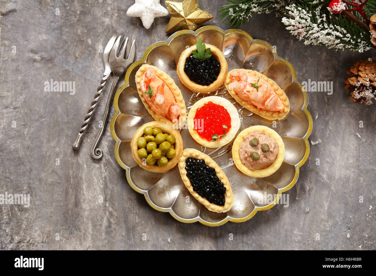 Christmas appetizers. Small tartlets with caviar and pate. Buffet and ...
