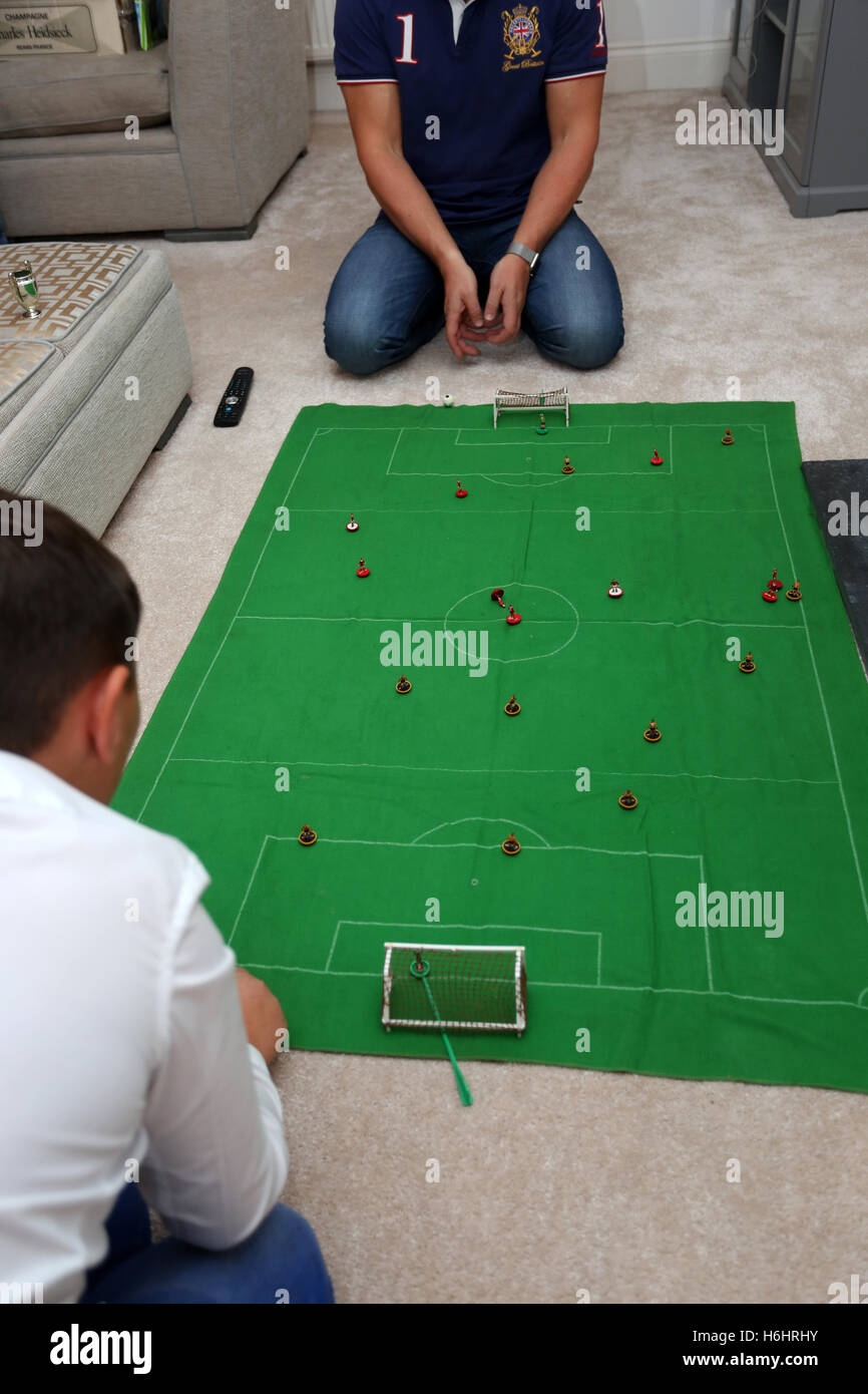 A father and his son pictured playing the Subbuteo football game in ...
