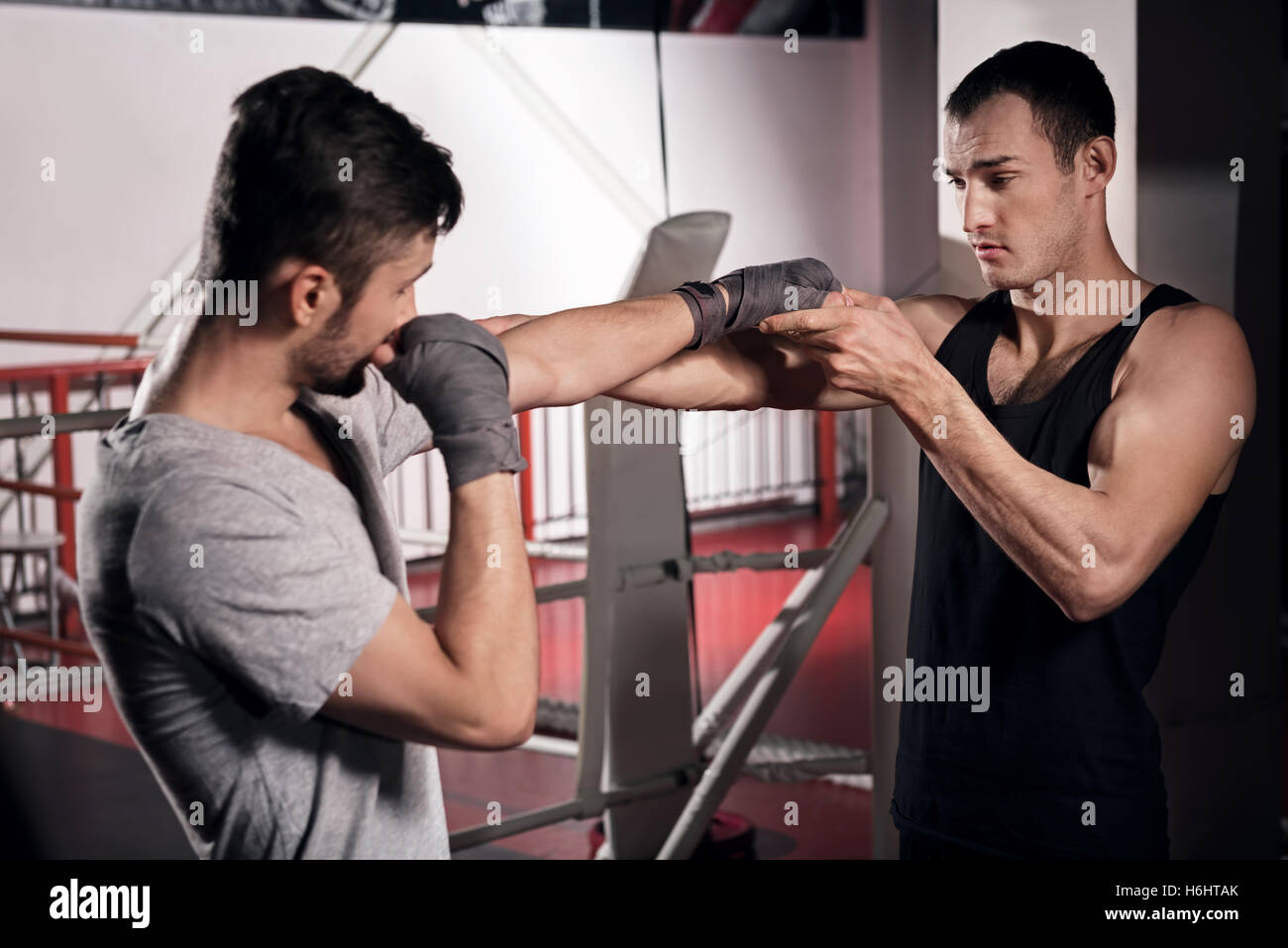 Trainer teaching a man how to box Stock Photo - Alamy