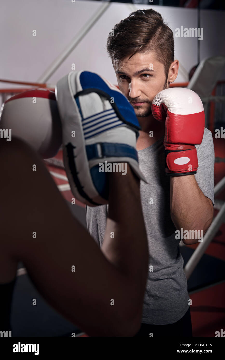 Nice boxer training hook on pad Stock Photo - Alamy