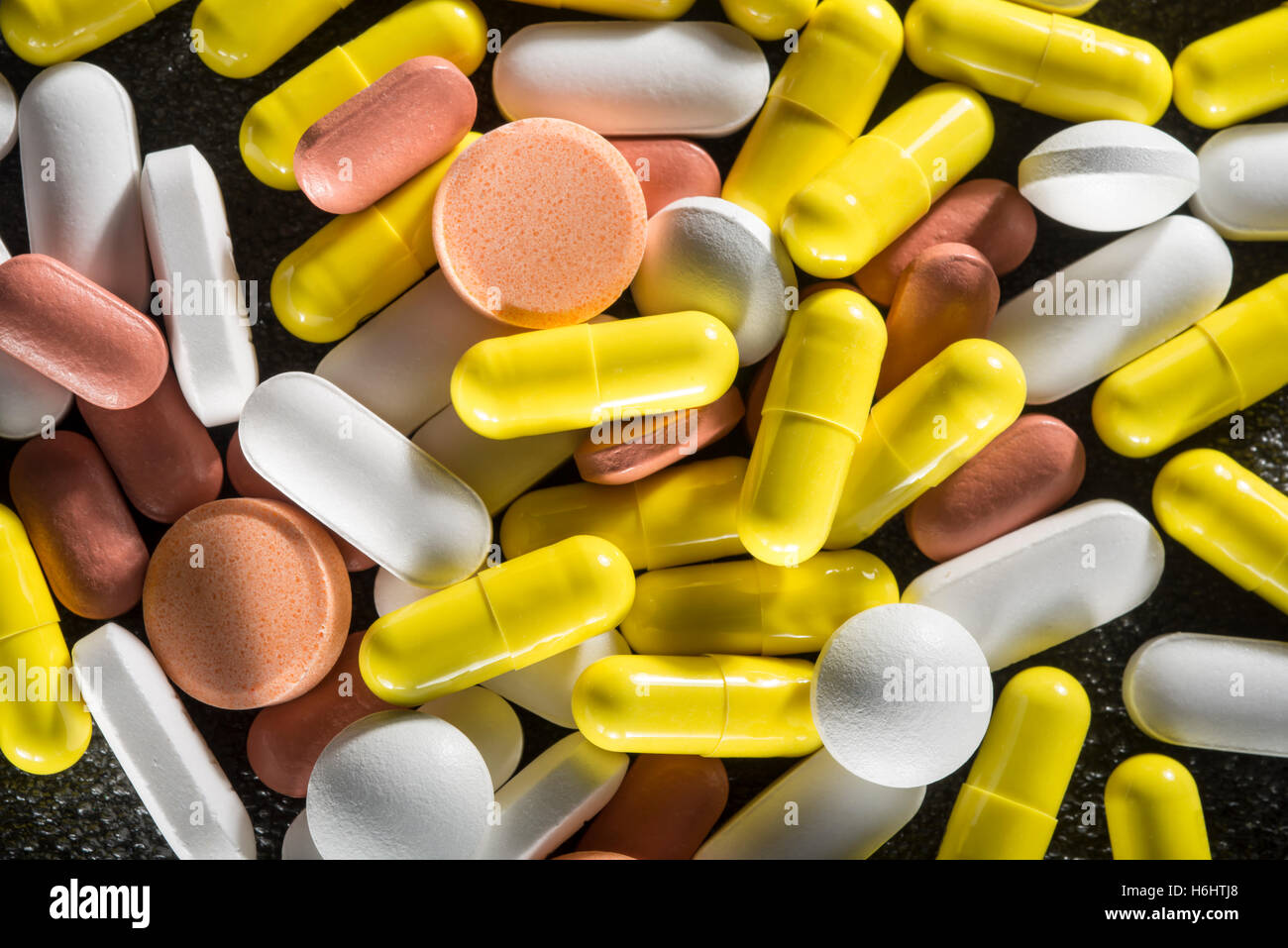 Stack of different colorful pills Stock Photo - Alamy