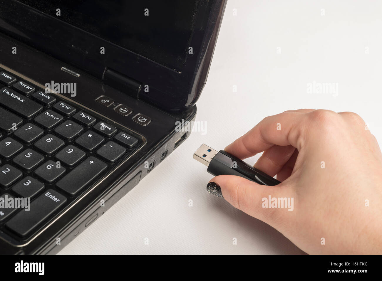 Hand inserting usb memory stick to laptop computer Stock Photo - Alamy