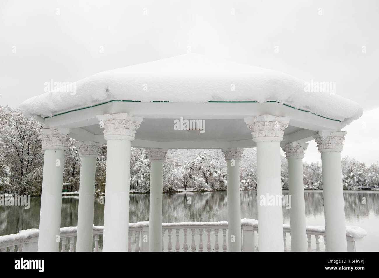 beautiful gazebo with columns on a background of the winter lake and ...
