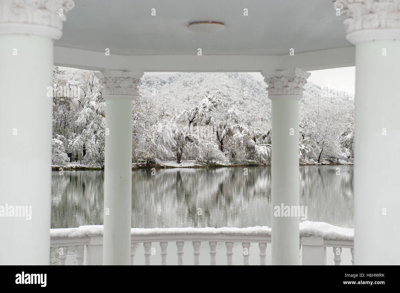 pavilion with columns on a background of the winter lake and the park ...