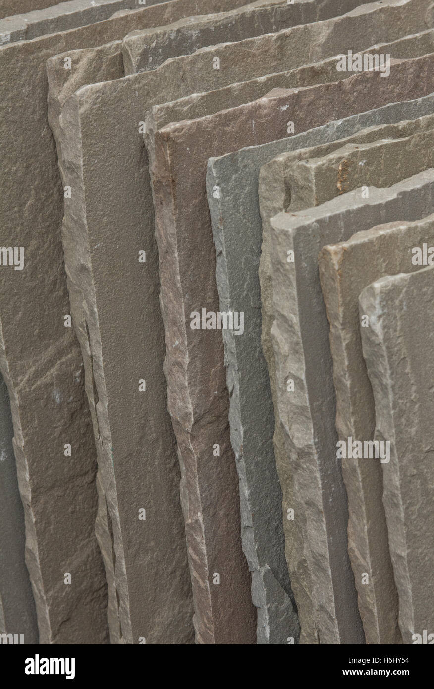 Slabs of Indian stone slate are piled up ready to use for laying a new ...