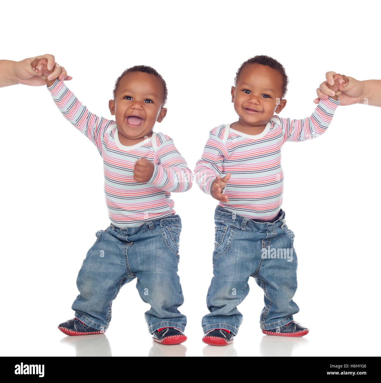 Funny couple of identical brothers learning to walk isolated on a white ...