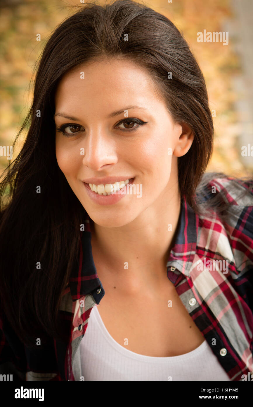 Beautiful brunette girl taking a walk by a park in autumn Stock Photo ...