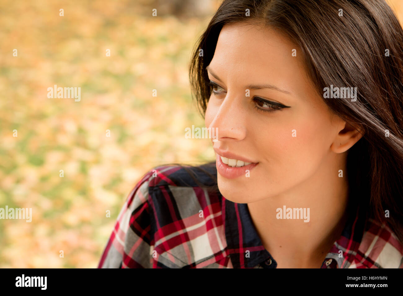 Beautiful brunette girl taking a walk by a park in autumn Stock Photo ...