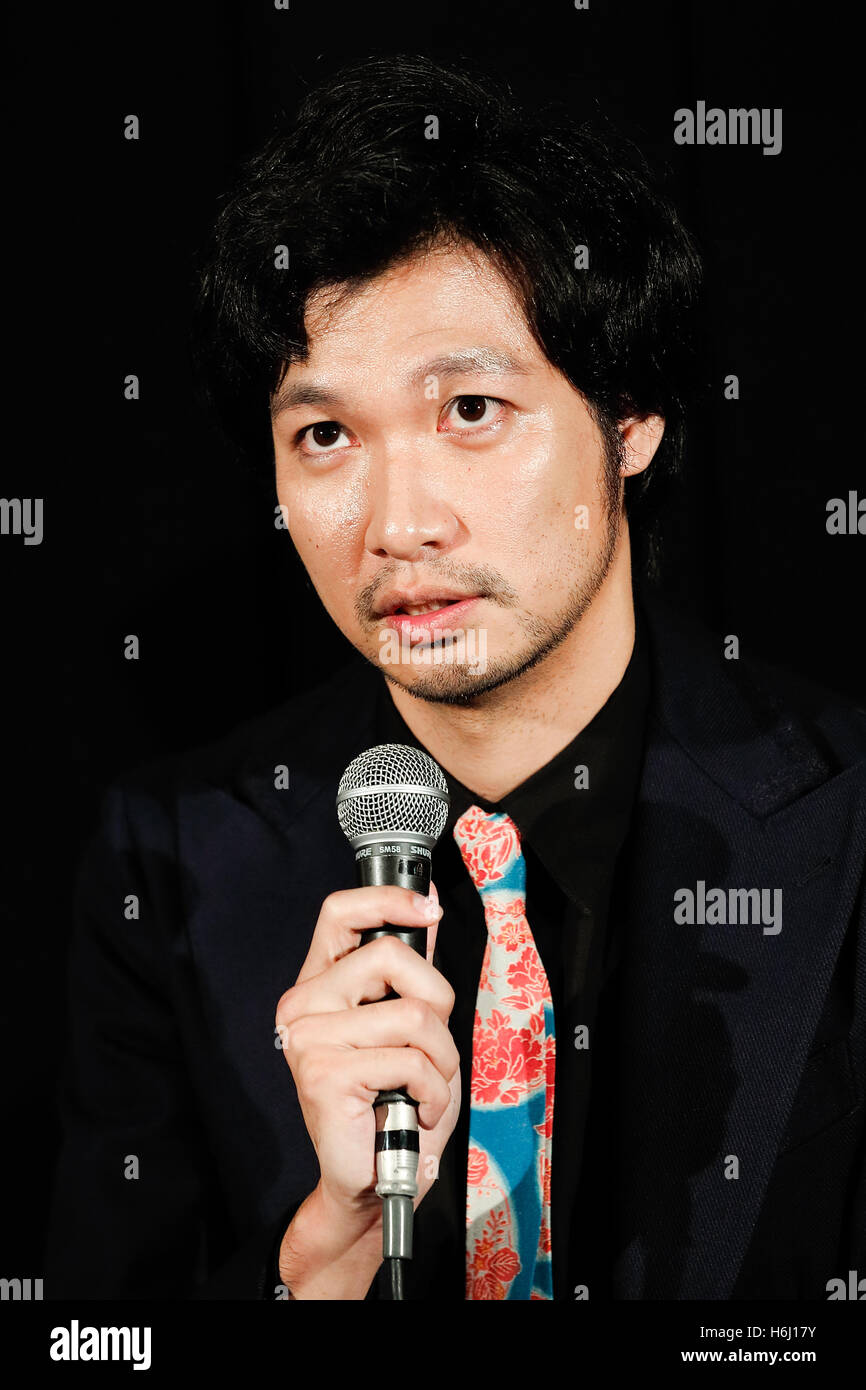 Actor Munetaka Aoki speaks during a stage greeting for the film A WOMAN ...