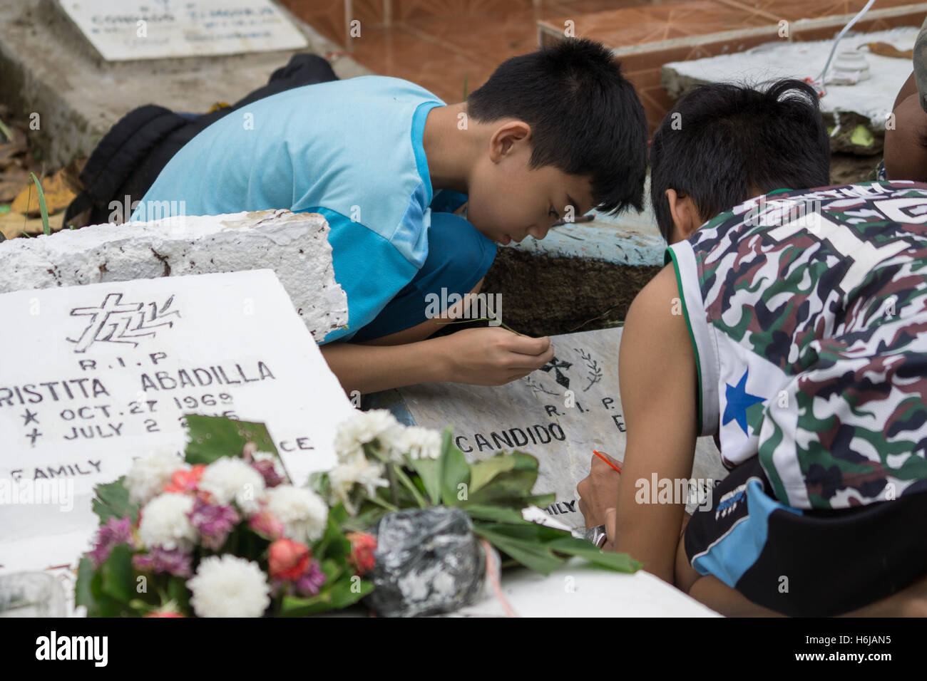 30/10/2016,Calamba Cemetery,Cebu City,Philippines.Children repair ...