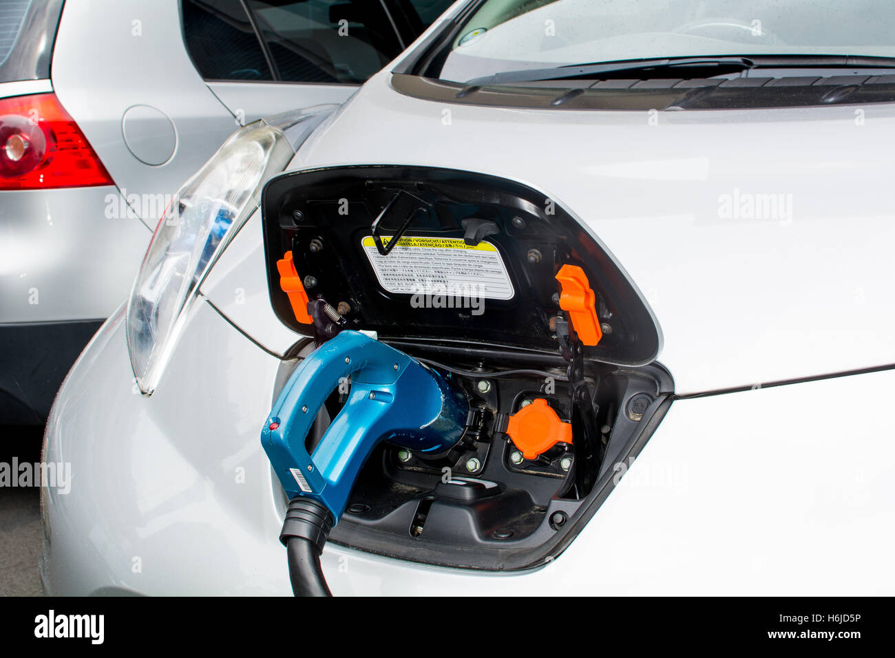 Charging of an electric car at a free at a free charging station Stock ...