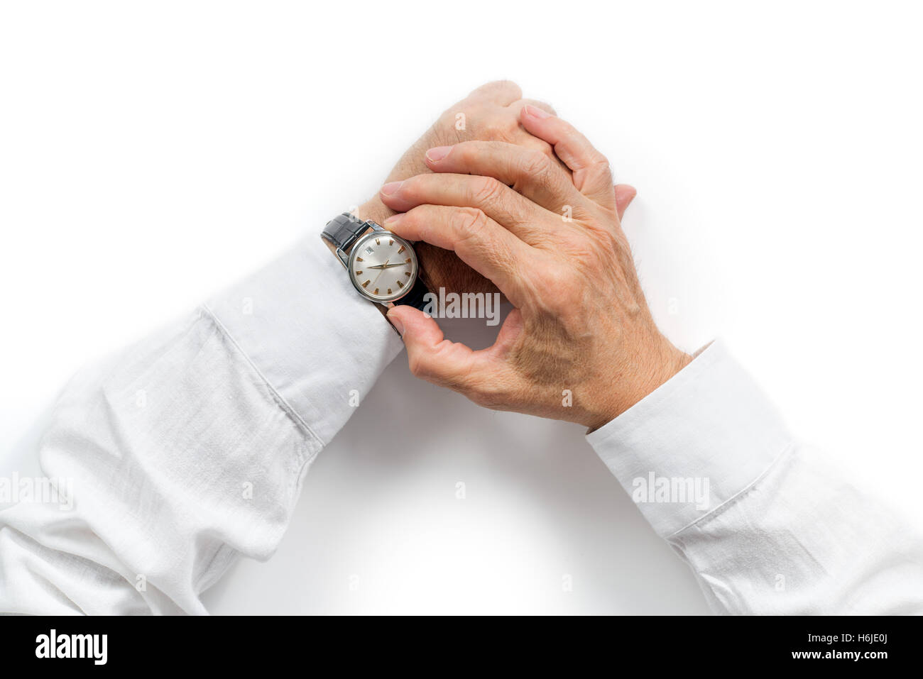 hands of a man watching the time on a wristwatch. Isolated Stock Photo ...
