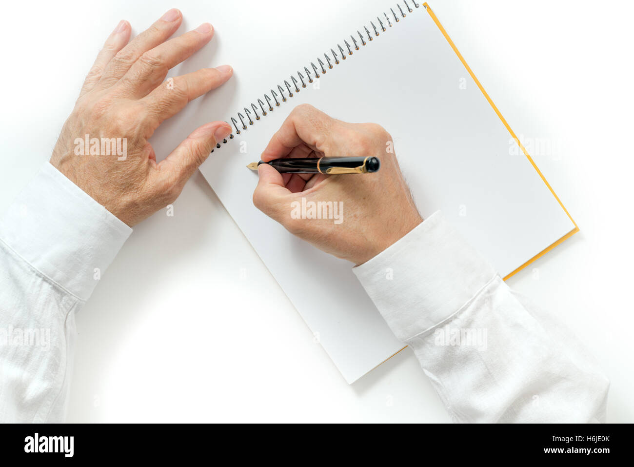 man's hand writing with a fountain pen. isolated Stock Photo - Alamy